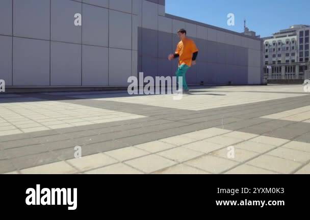 young energetic guy dancer breakdancing outdoors and standing on hand ...