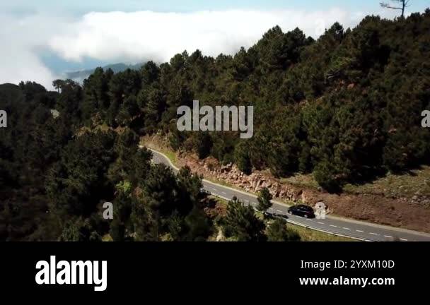 Aerial drone shot over Madeira summits and peaks. Winding roads in ...