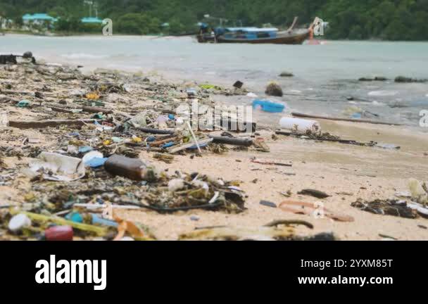 Polluted beach with plastic waste and debris on the sea coast on Phuket ...
