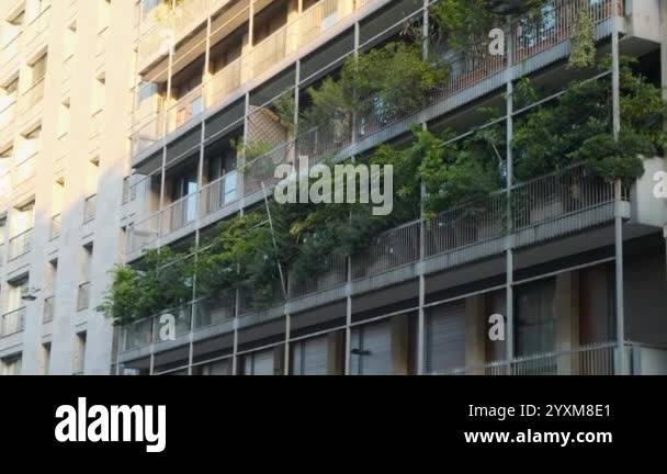 Modern apartment building with vertical garden on balconies, creating ...