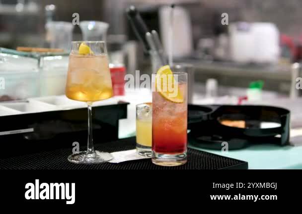close-up in a professional kitchen, pours alcohol into a cocktail from ...