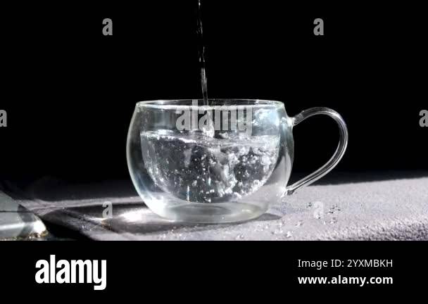 Pure Water Poured Into Glass closeup on light gray background. Super ...