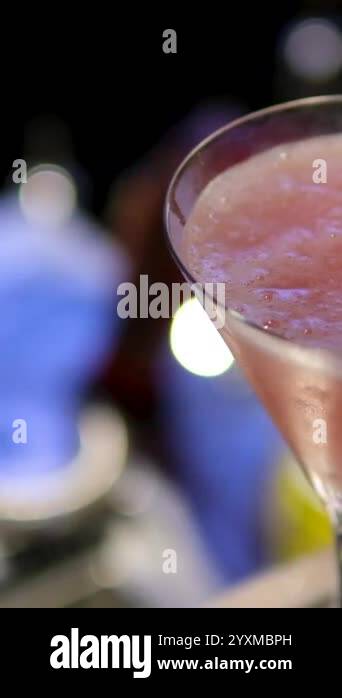 Cropped view of Martini drink. Cocktail Cosmopolitan elegant transparent glass. alcoholic ...