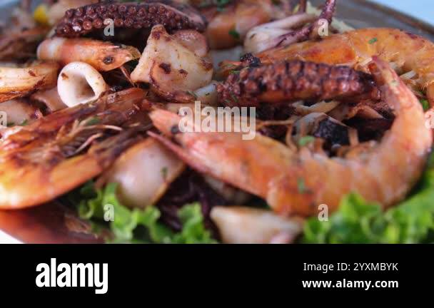 Delicious platter of seafood and fried fish on a table overlooking a ...