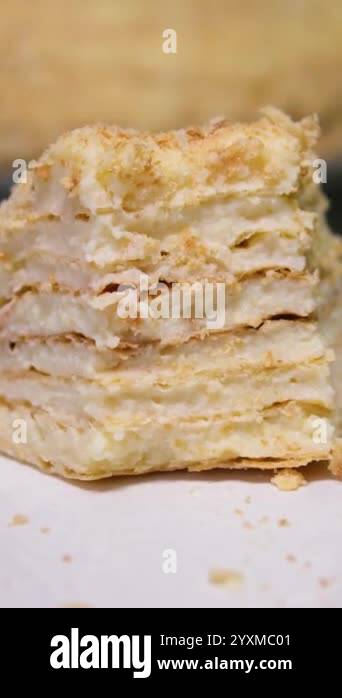 Portion of multi layered cake, cut off with funny spoon. Puff pastry ...