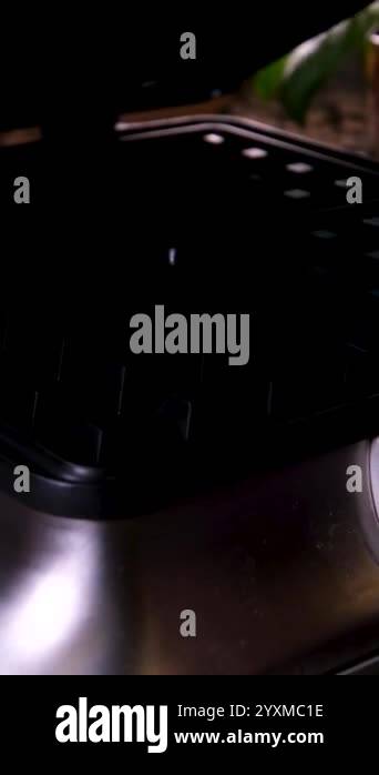 Woman in a white shirt prepares waffles in her kitchen. Opening the ...