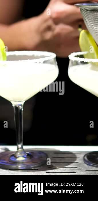 hand bartender using strainer in vodka coconut smooth fizzy cocktail at ...