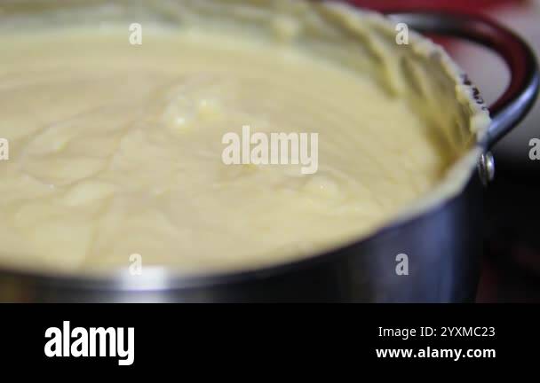 Mashing potatoes in a pot. Cooking food in the kitchen. Boiled ...