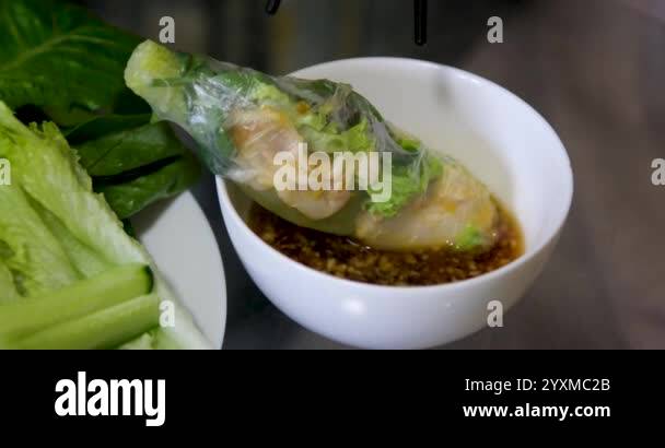 Spring roll dipped into sauce. repeatedly Stock Video Footage - Alamy