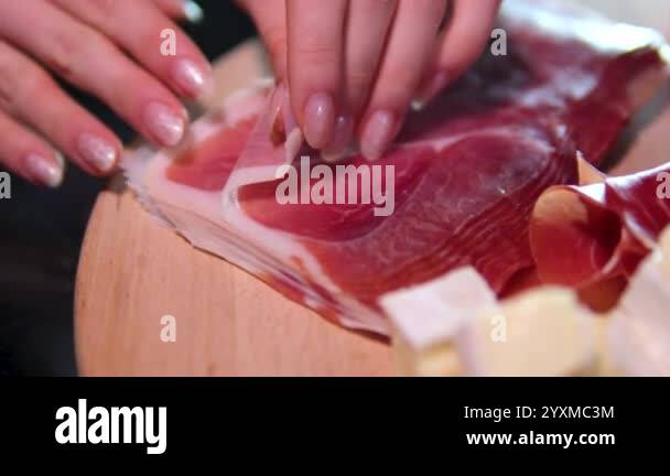 Prosciutto crudo or jamon meat or Iberian ham slices on slice of ...