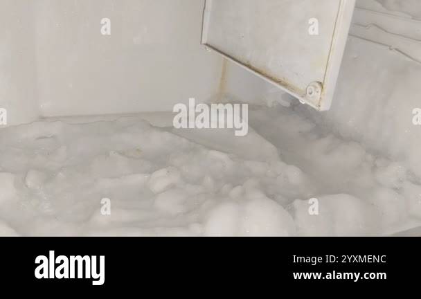 the process of melting the ice in the refrigerator freezer Stock Video ...