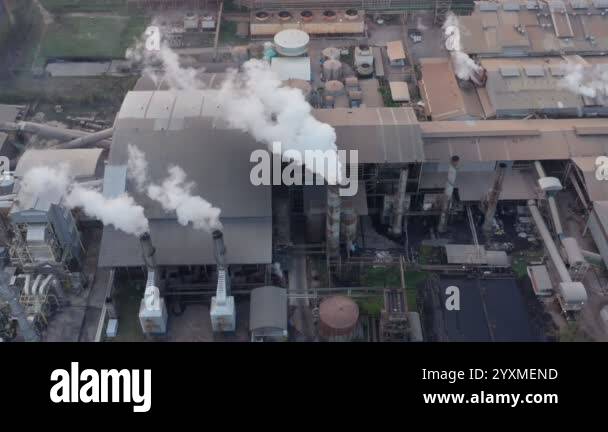 Aerial view Drone shot of flying around toxic chimneys tubing. Air ...