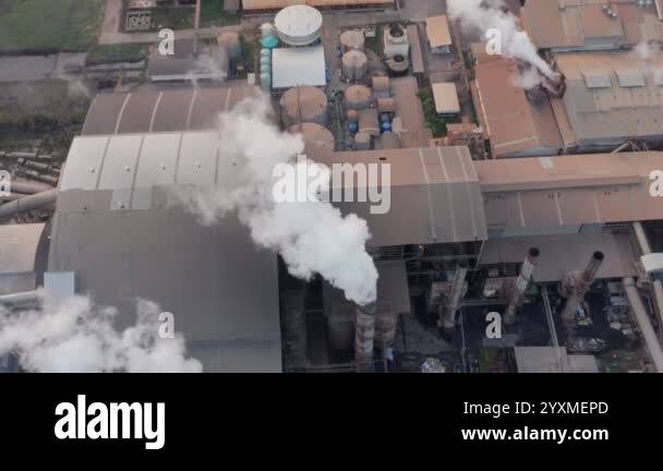 Aerial view Drone shot of flying around toxic chimneys tubing. Air ...