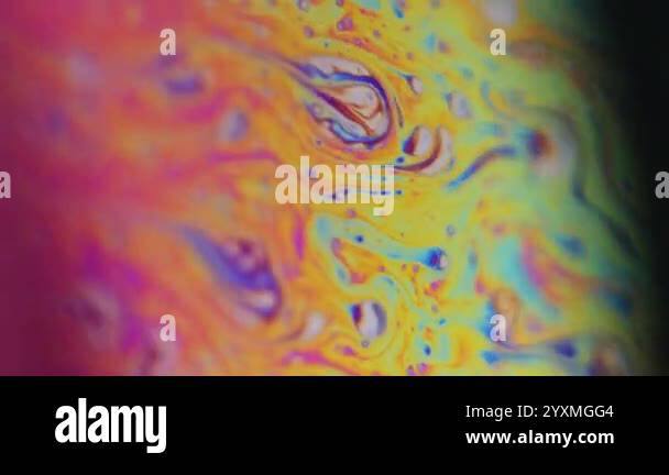 Gasoline fluid. Psychedelic spectrum. Defocused yellow pink blue color ...