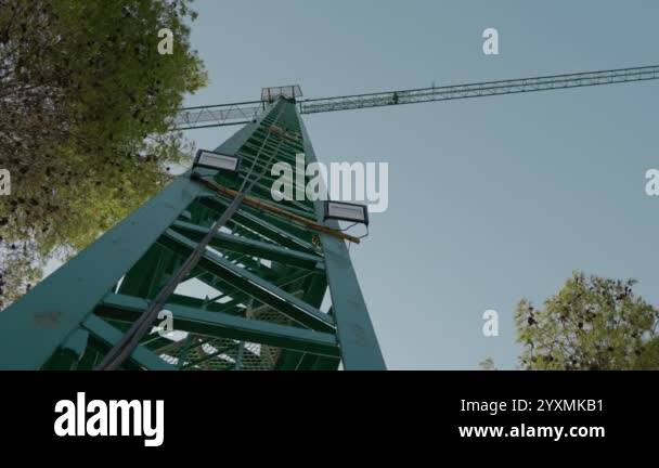 A striking view of a green tower stretching upwards under a clear sky ...
