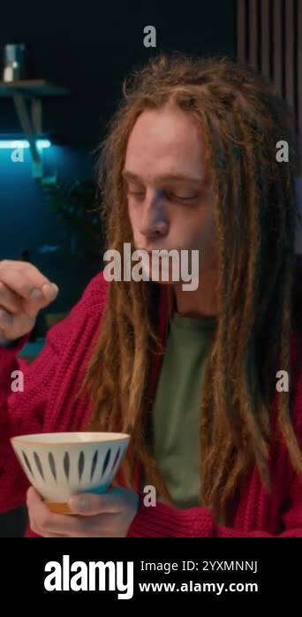 Vertical medium slowmo portrait of young Caucasian hipster guy with ...