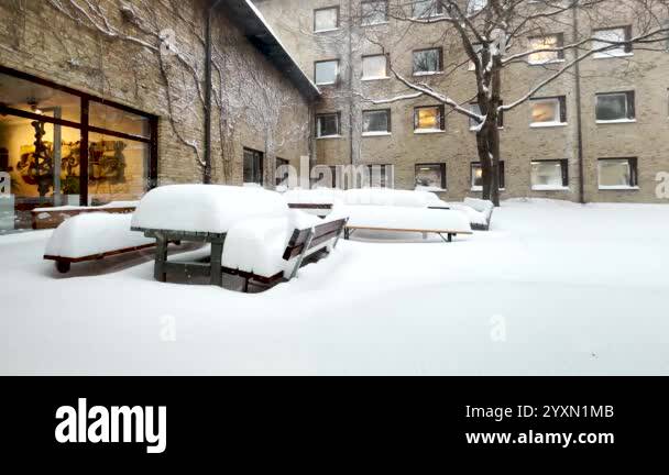 Christmas slowmotion snowfall in 4K video in building background with ...