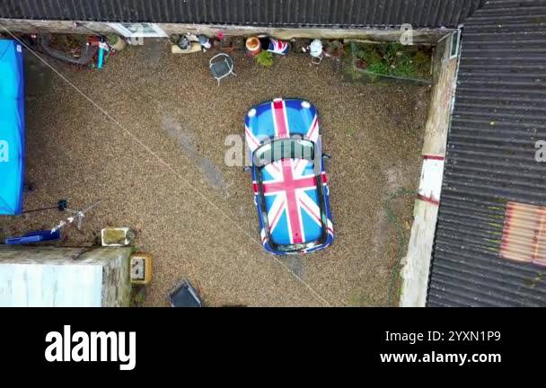 Aerial drone footage of a mini Cooper car painted with a traditional ...
