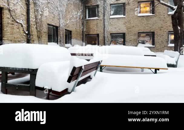 Christmas slowmotion snowfall in 4K video in building background with ...