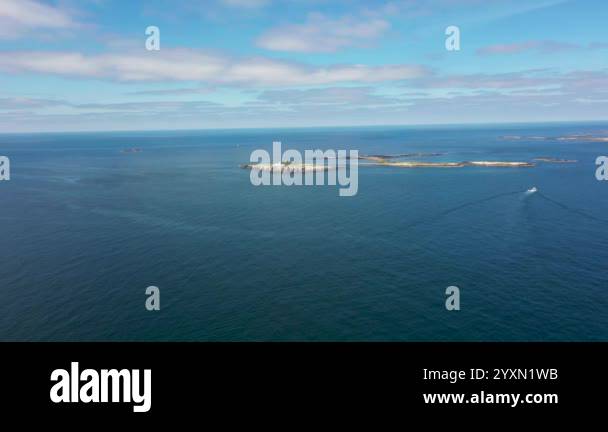 Aerial footage of the seaside coastal town of the village of Seahouses ...