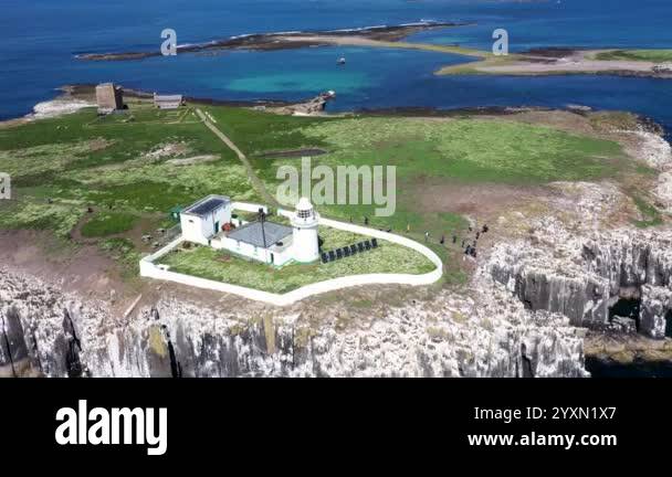 Aerial footage of the seaside coastal town of the village of Seahouses ...