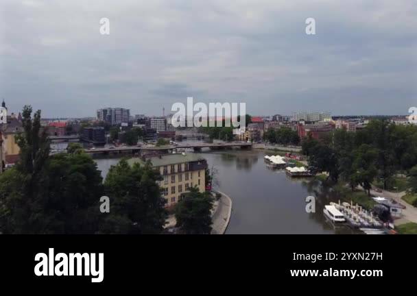 A drone flyover above a river in the center of an old town, showcasing ...