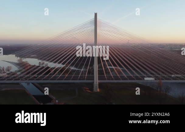 A horizontal drone shot at sunset of a stunning, massive cable-stayed ...