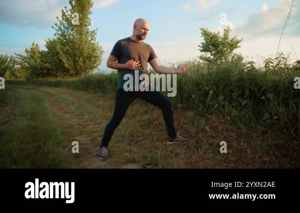 Bald man passionately performing on imaginary guitar, striking dynamic ...