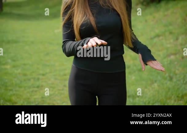 Woman energetically moving hips and arms during lively dance. Female shaking hips and waving ...