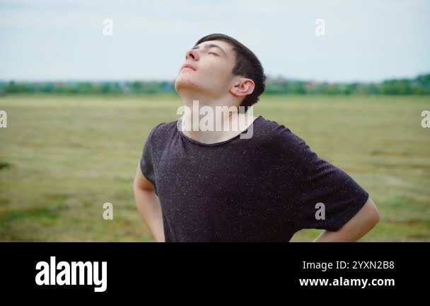 Teenage guy warming up neck with tilts to improve brain circulation and ...