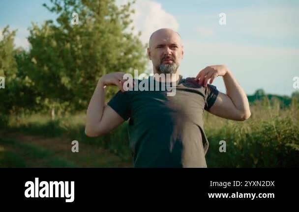 Relaxed male stretching and rolling shoulders to relieve fatigue and ...