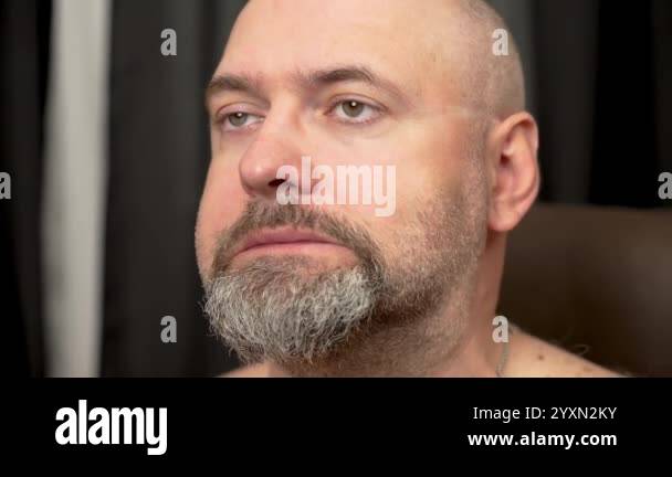Bald man scratching gray beard. Hairless male itching gray beard. Bald ...