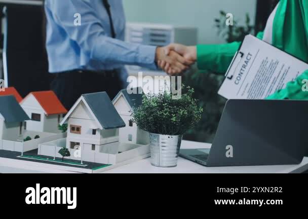 real estate agent giving keys to young couple after signing contract to ...