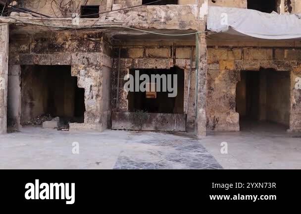 Heavily damaged building in Aleppo, Syria, bears the scars of ...