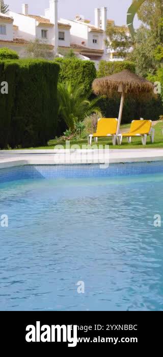 Portrait footage of a beautiful swimming pool in the summer time ...