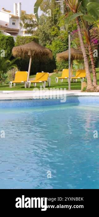 Portrait footage of a beautiful swimming pool in the summer time ...