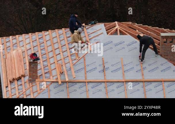 LVIV, UKRAINE - DECEMBER 05, 2024: Male construction workers building a ...