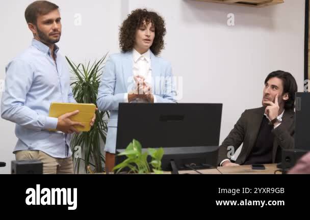 Confident businesswoman gives presentation with male colleague in ...