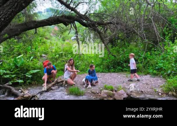 A group of kids with parents joyfully enjoying a playful moment by a ...