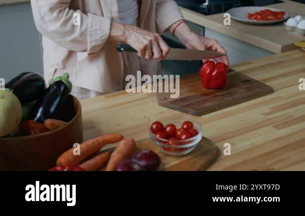 Cropped shot of unrecognizable woman coring and cleaning red bell ...