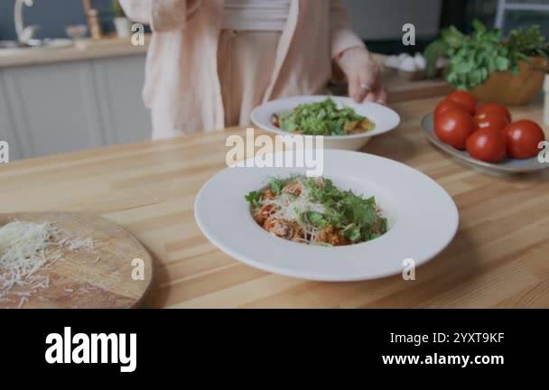 Adult Caucasian woman enjoying process of plating and decorating two ...