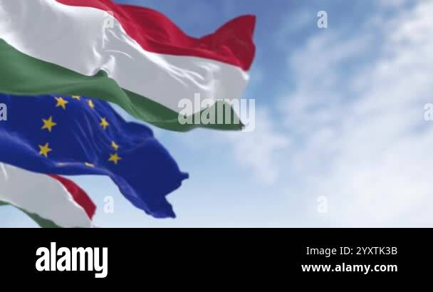 Flags of Hungary and the European Union fluttering together on a clear ...