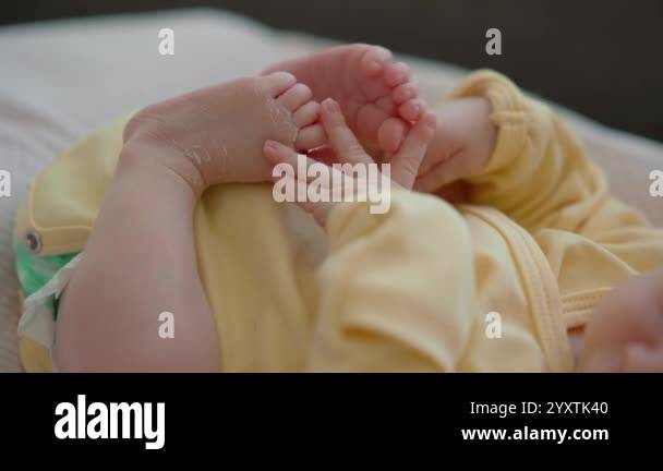 Close-up video of a newborn babys legs with peeling skin, a common ...