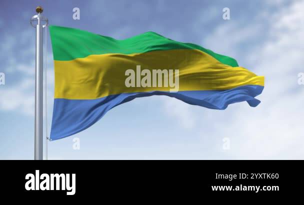 National flag of Gabon waving in the wind on a clear day. Three equal ...