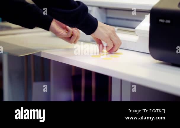 paper load to plotter craft DIY home factory equipment close-up hand ...