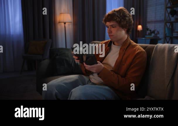 Man spending free time at home. Young man spending evening at home ...