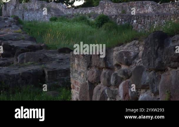 The remnants of a medieval castle, showcasing stone foundations and ...