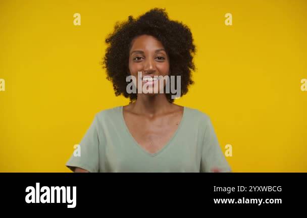 Excited woman with cheerful expression raising fists in a celebratory ...