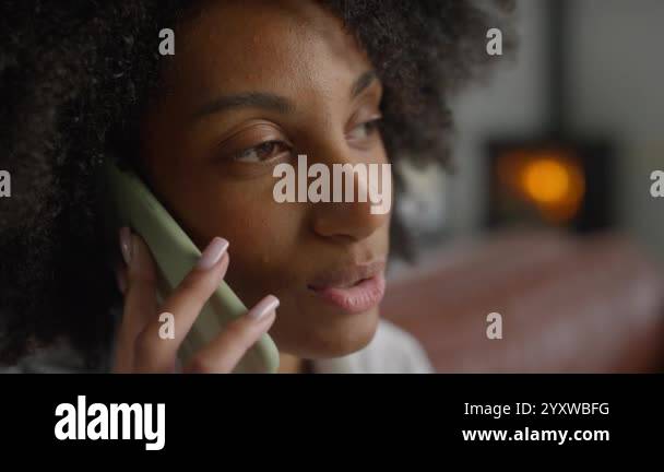 Close up shot of a woman having a phone conversation, with a warm and ...
