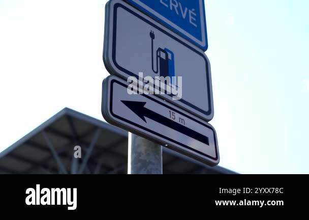 Road sign showing the direction to the charging station for electric ...